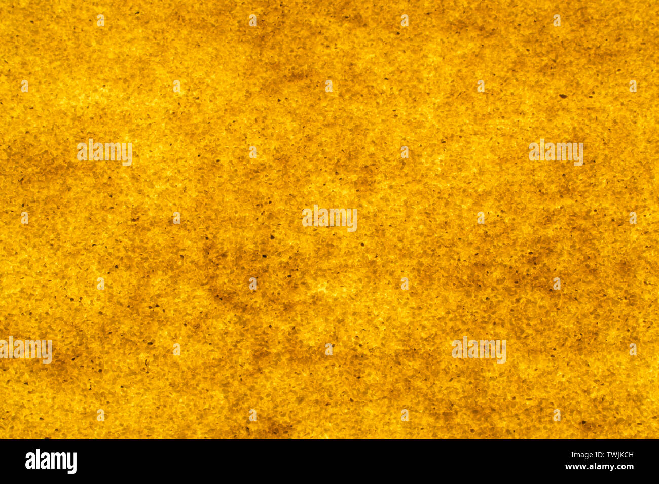 bright background of golden sand granules. backlit background Stock ...
