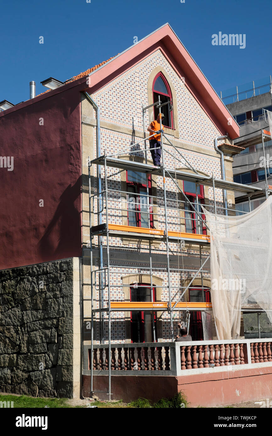 Workers working on a construction site working on tiles modernising the ...
