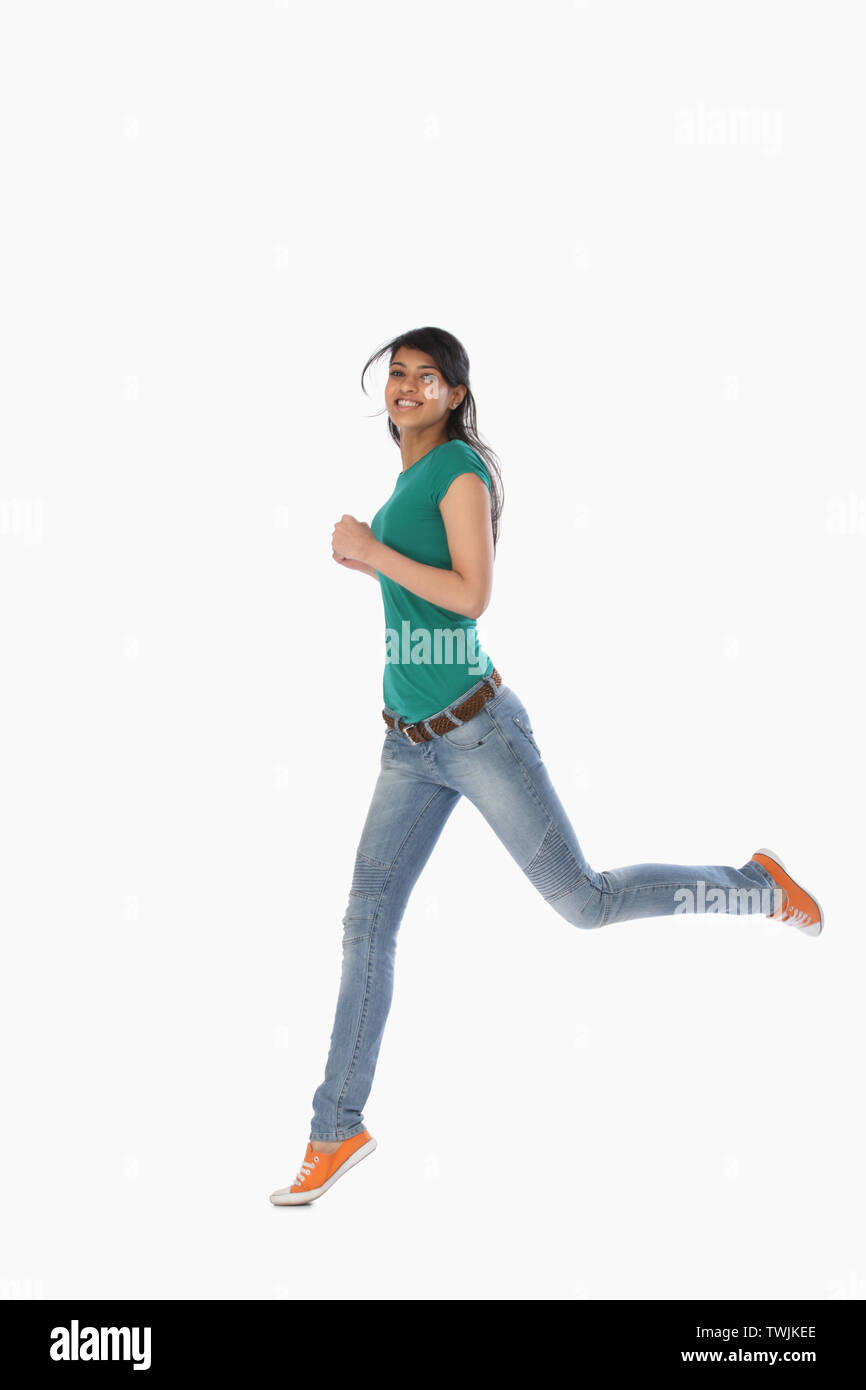 Woman running and smiling Stock Photo - Alamy