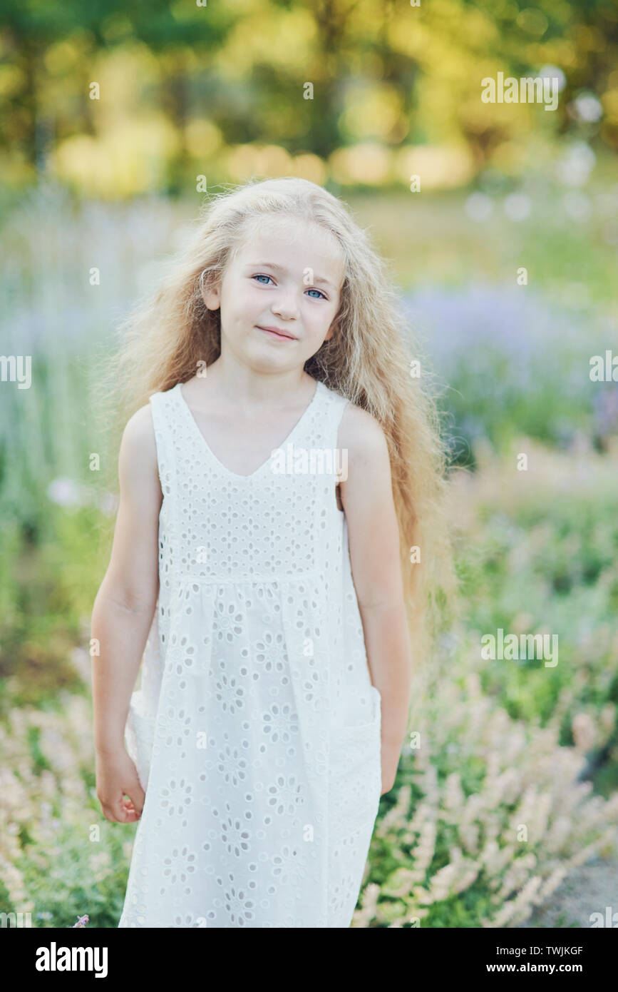 Close up portrait of pretty, blue eyed, fair skinned girl with happy ...