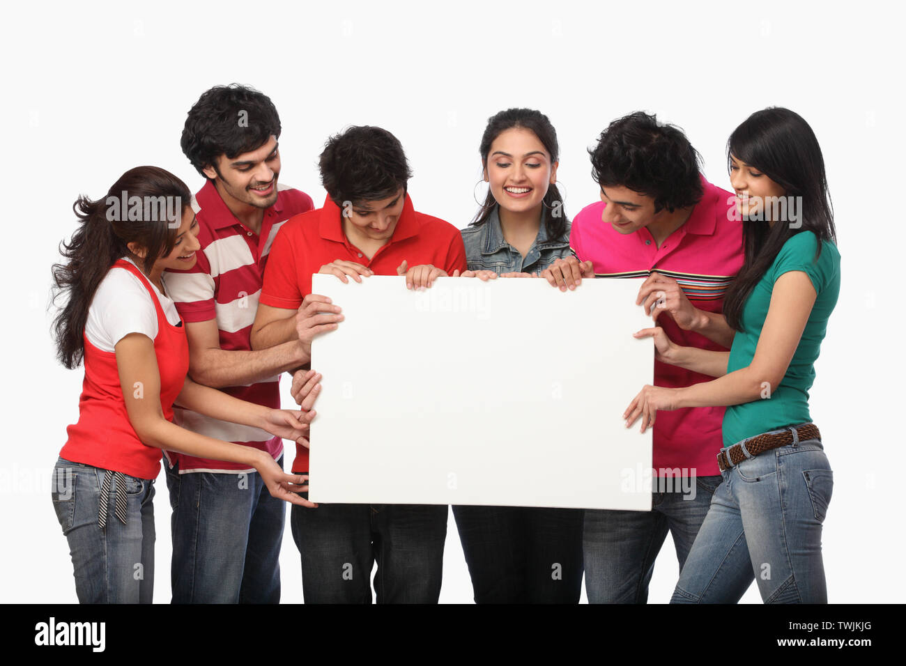Group of friends holding a placard and smiling Stock Photo - Alamy