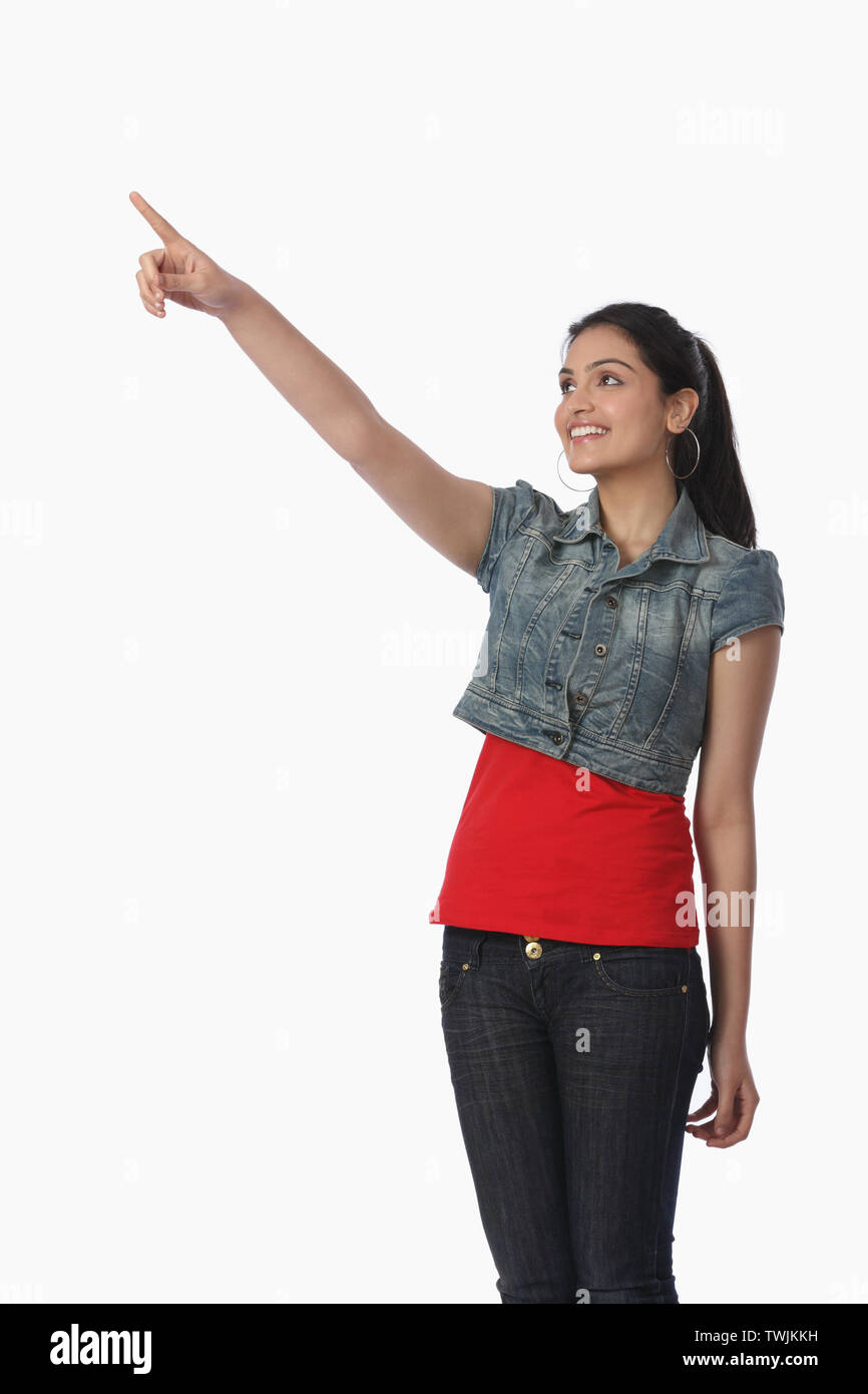 Woman pointing upward and smiling Stock Photo - Alamy