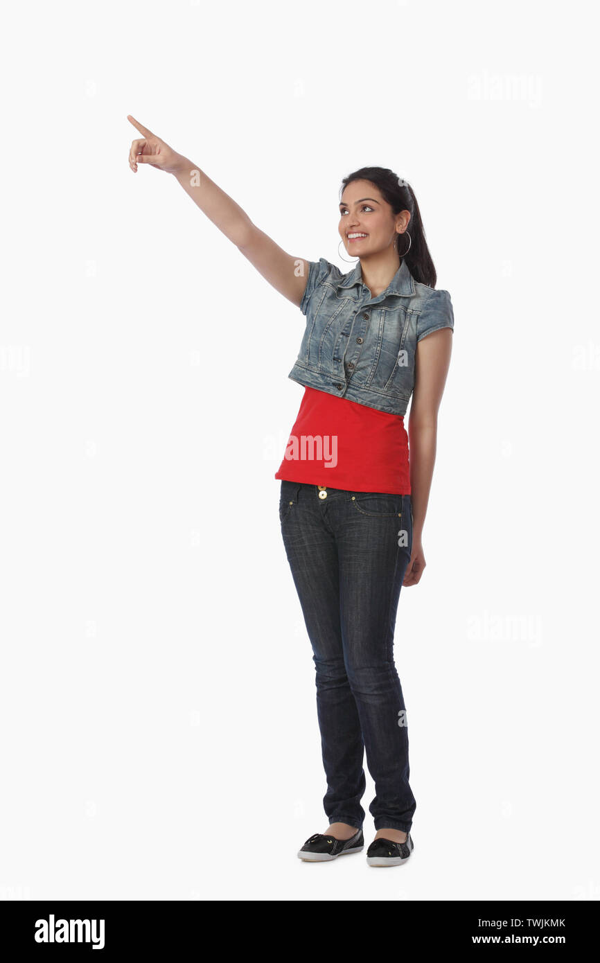 Woman pointing upward and smiling Stock Photo - Alamy