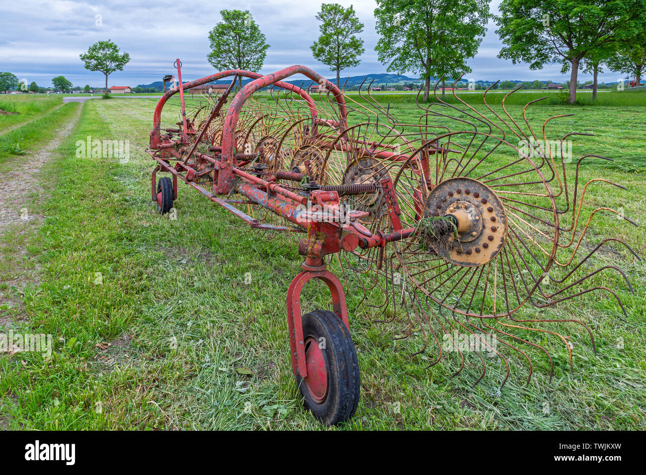 Old hay tedder on a meadow in Bavaria Stock Photo - Alamy