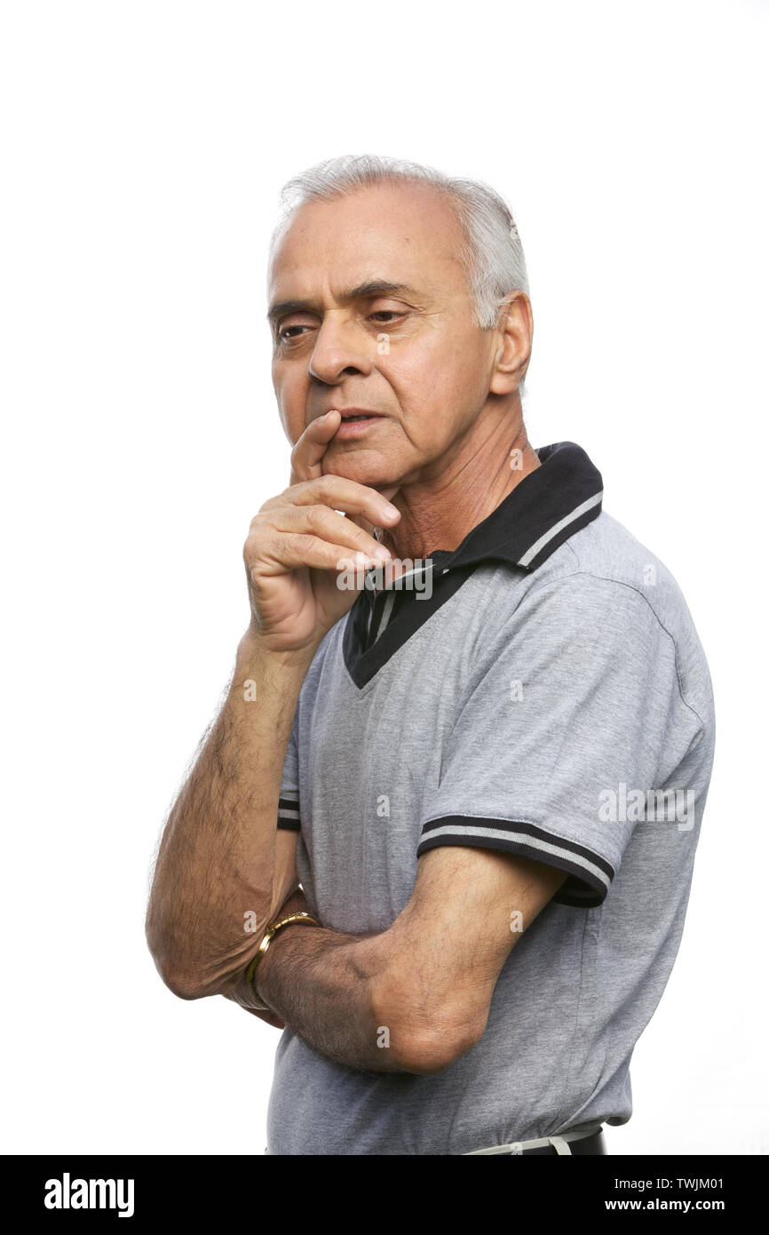 Old man thinking with hand on chin Stock Photo - Alamy