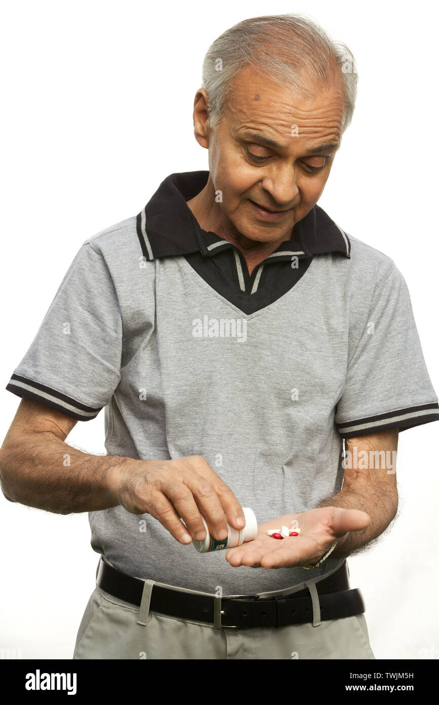 Old man pouring prescription medication into hand Stock Photo - Alamy