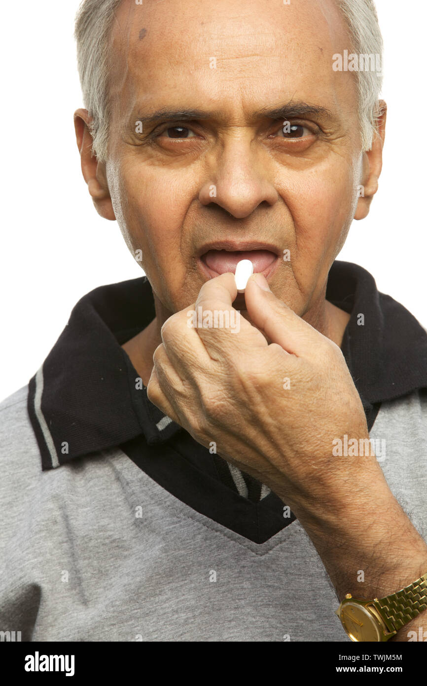 Indian old man taking medicine hi-res stock photography and images - Alamy
