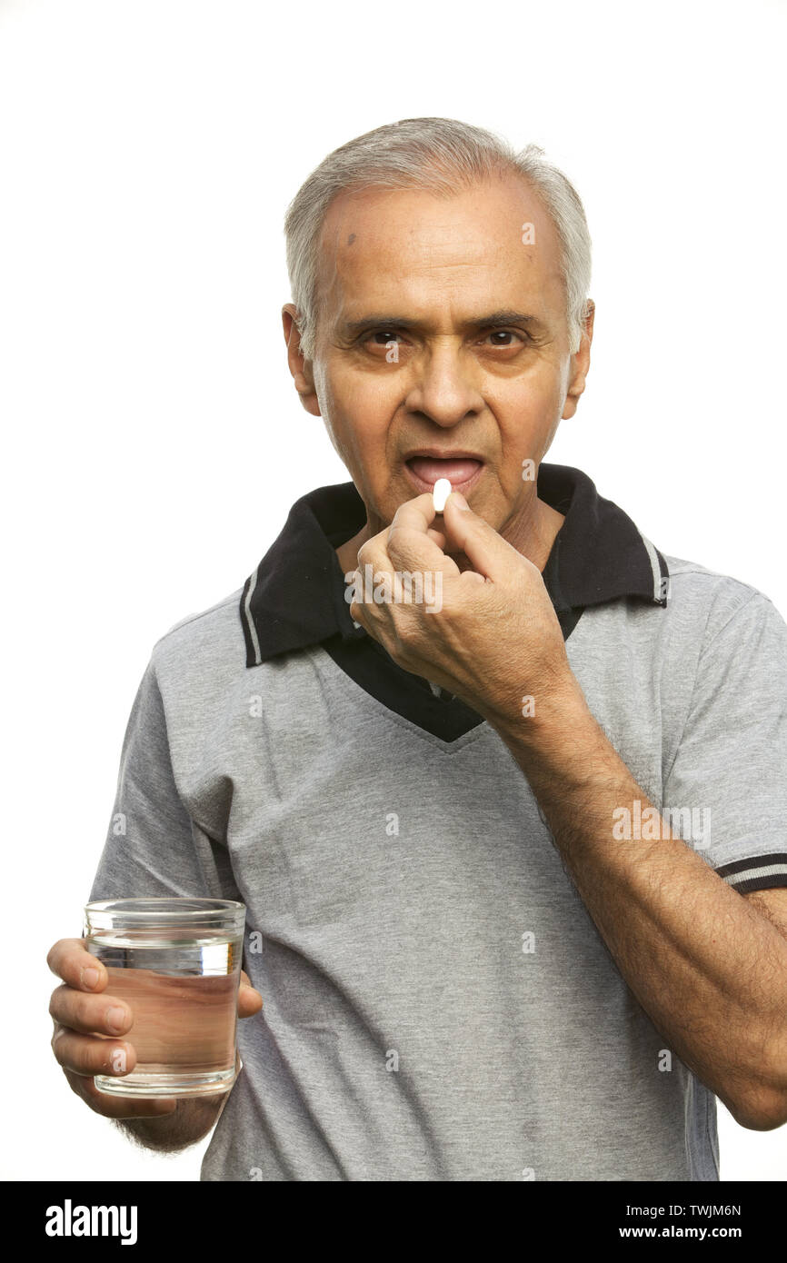 Old man taking medicine Stock Photo - Alamy