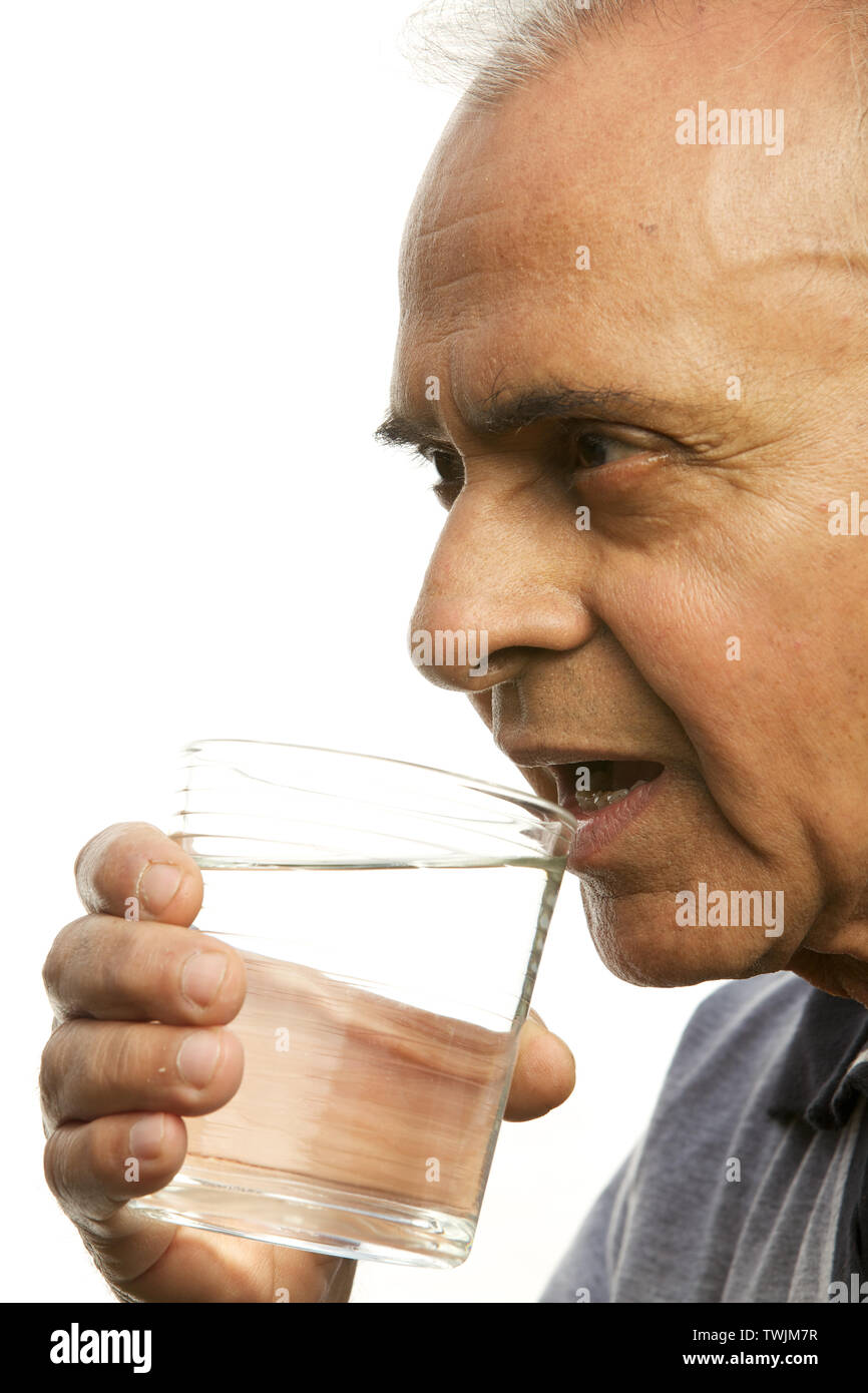 Old man drinking a glass of water Stock Photo - Alamy