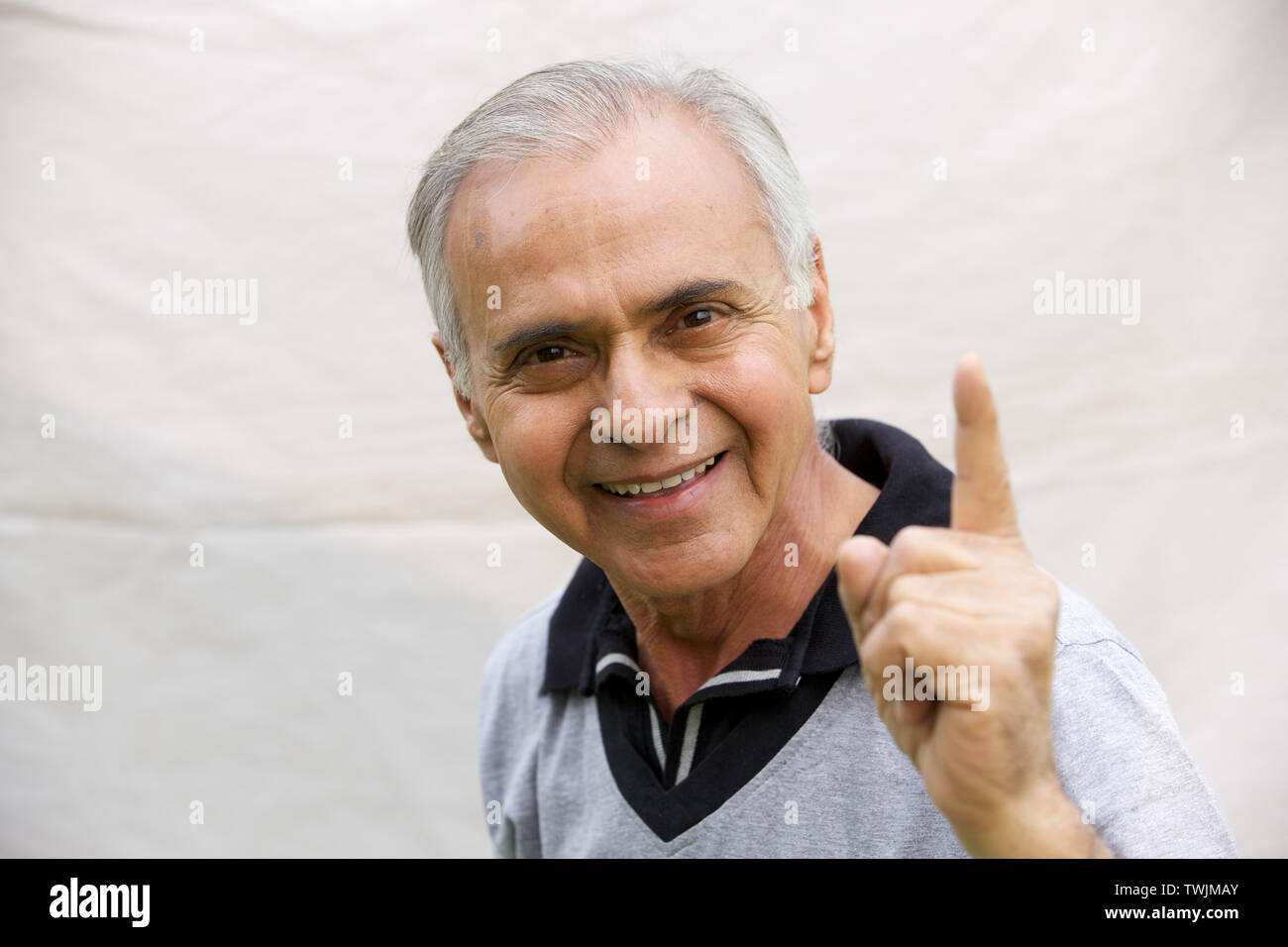 Old man pointing upward and smiling Stock Photo - Alamy