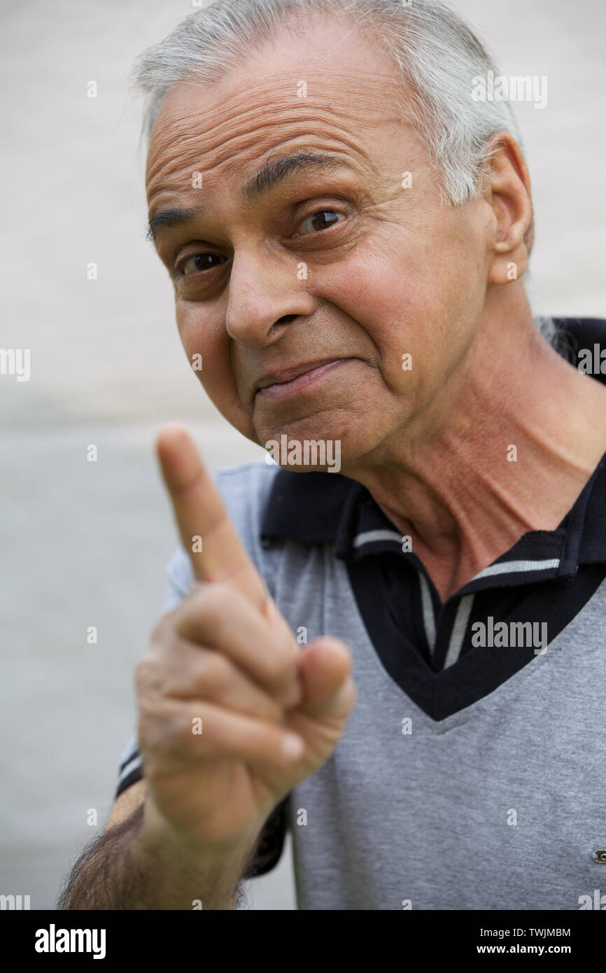 Old man pointing upward and smiling Stock Photo - Alamy