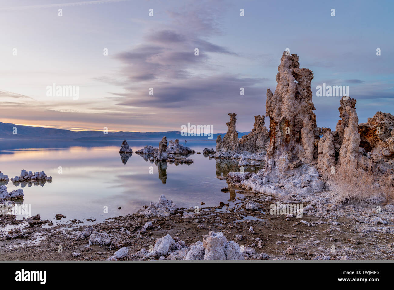 Ancient lake in a crater of an extinct volcano. Tufa stalactites are ...