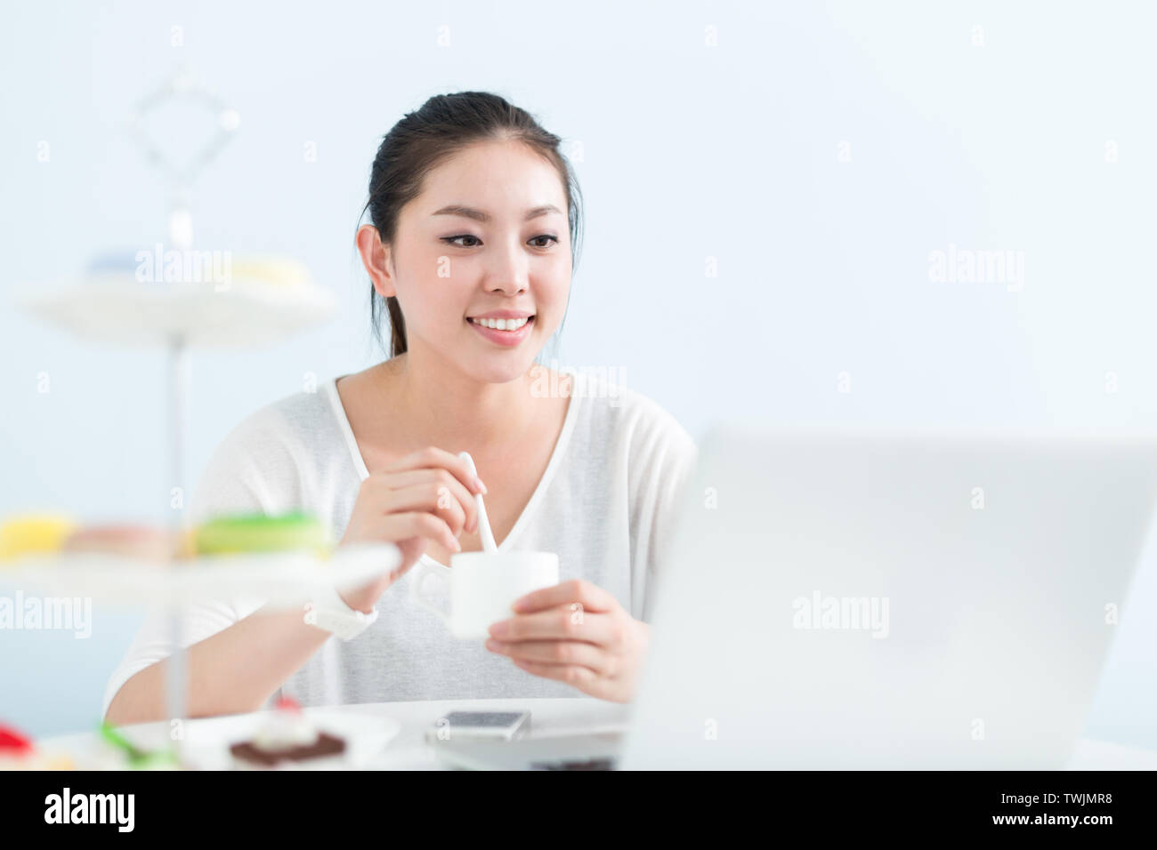 young pretty chinese woman working with laptop in office Stock Photo ...