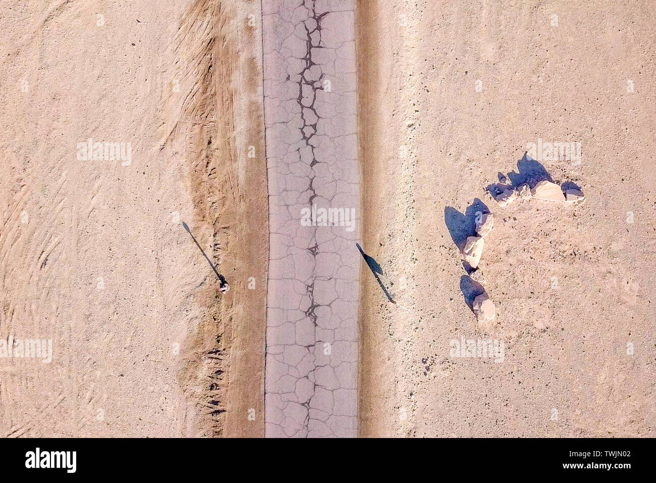 Old Desert road with cracked asphalt, Top down aerial image Stock Photo ...