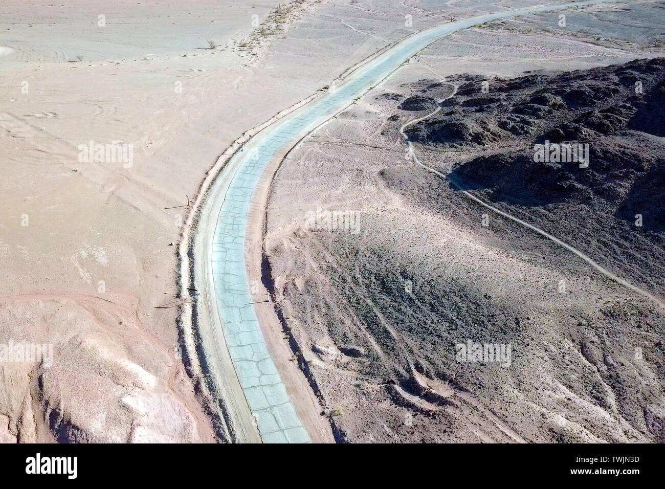 Old Desert road with cracked asphalt, Top down aerial image Stock Photo ...