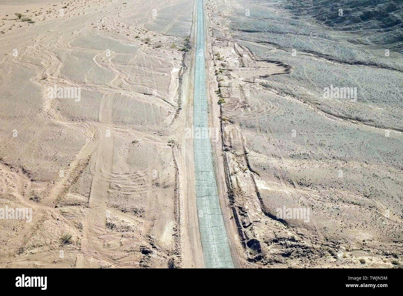 Old Desert road with cracked asphalt, Top down aerial image Stock Photo ...