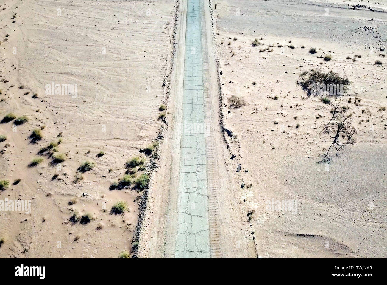 Old Desert road with cracked asphalt, Top down aerial image Stock Photo ...