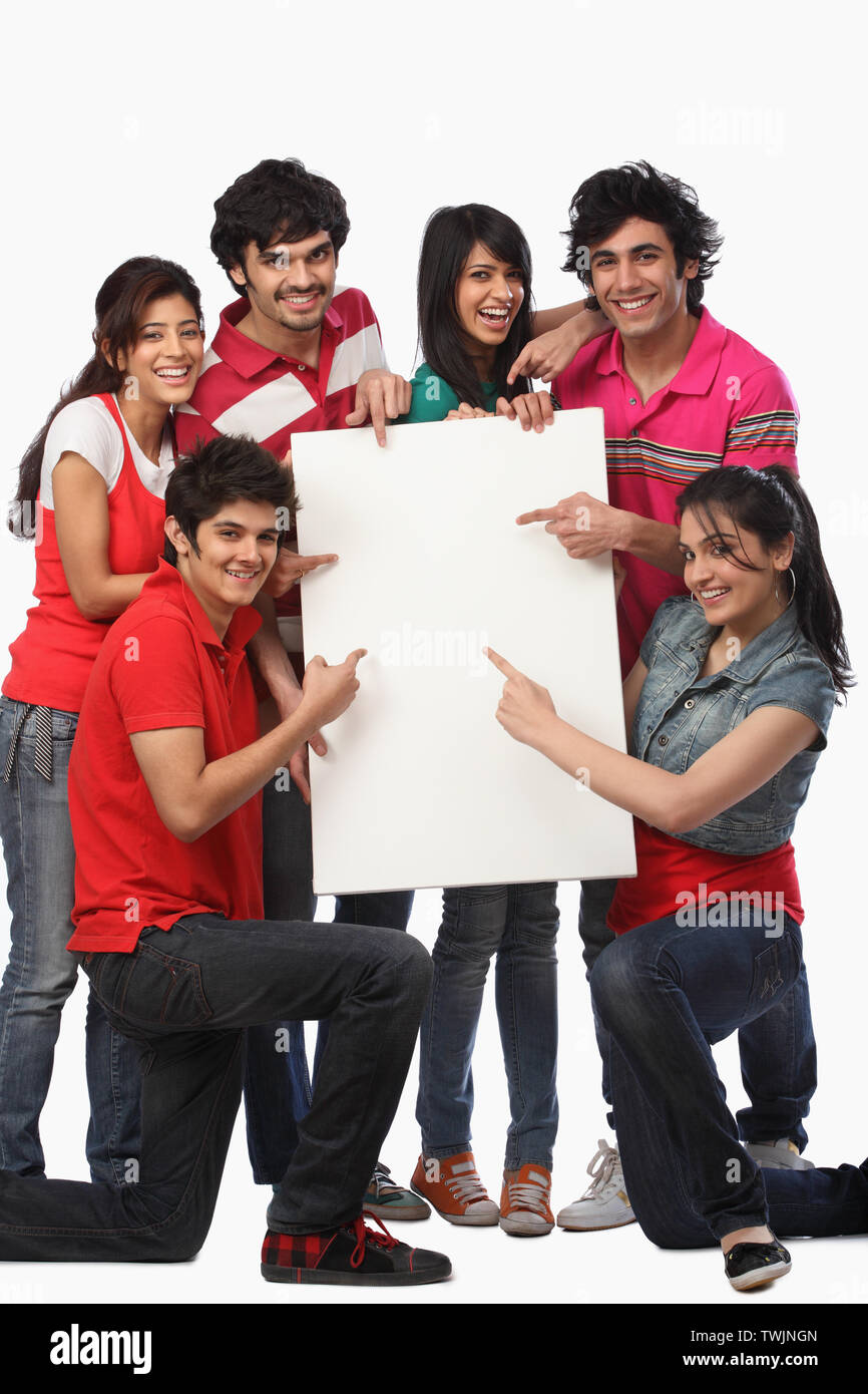 Group of friends holding a placard and smiling Stock Photo - Alamy