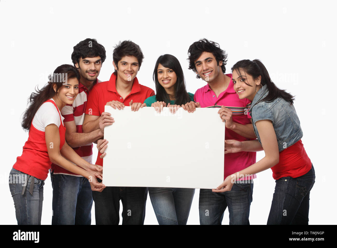 Group of friends holding a placard and smiling Stock Photo - Alamy