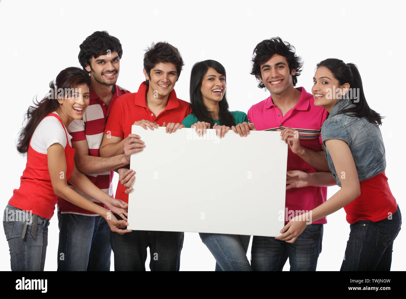 Group of friends holding a placard and smiling Stock Photo - Alamy