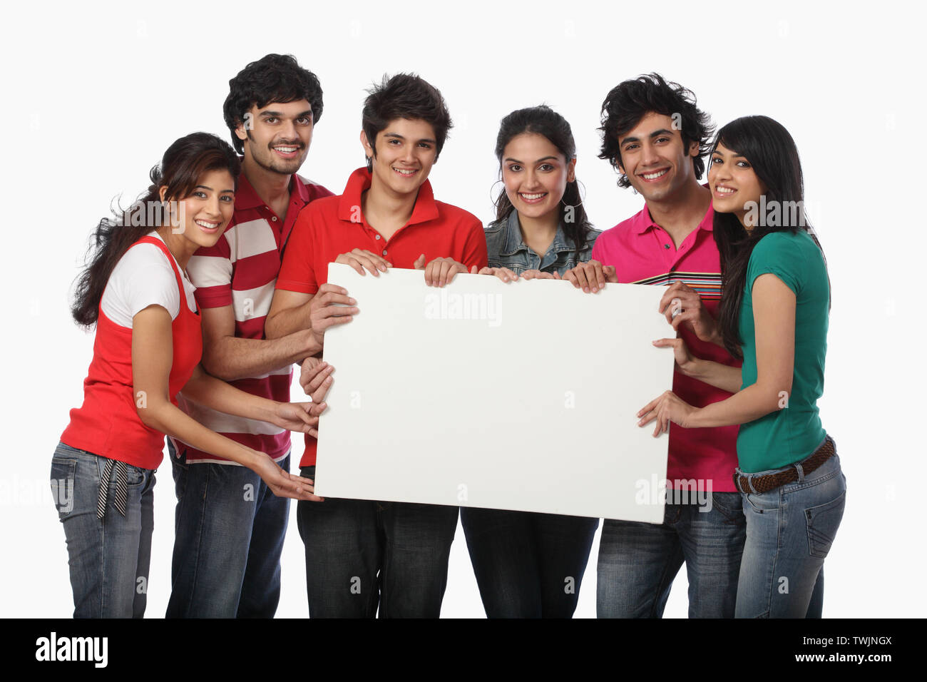 Group of friends holding a placard and smiling Stock Photo - Alamy