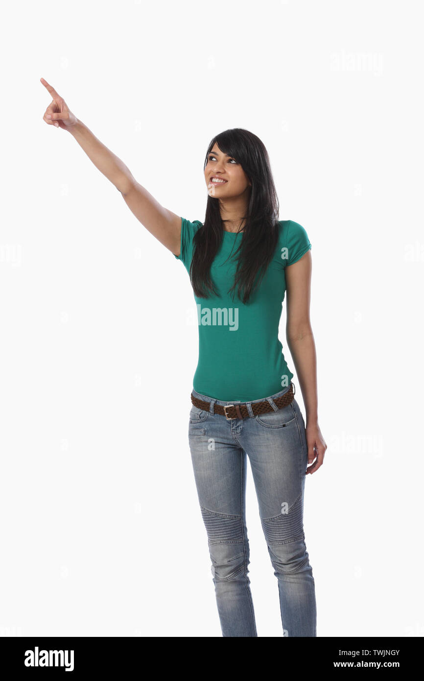 Woman pointing upward and smiling Stock Photo - Alamy