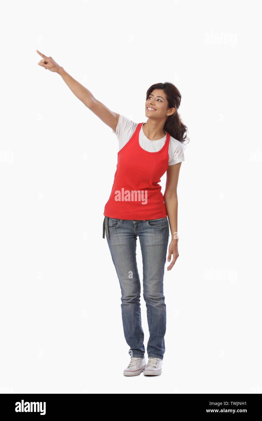 Woman pointing upward and smiling Stock Photo - Alamy