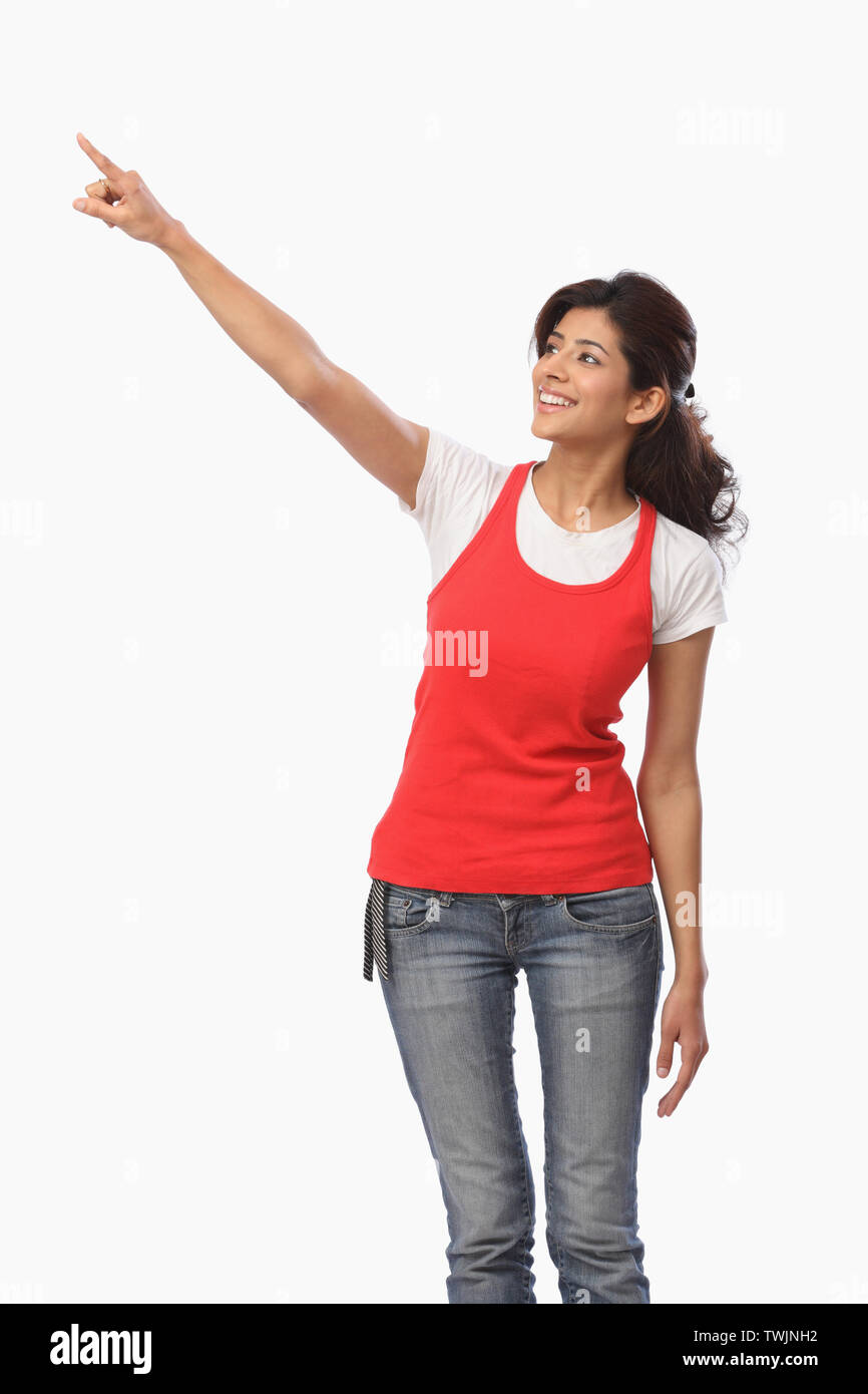 Woman pointing upward and smiling Stock Photo - Alamy