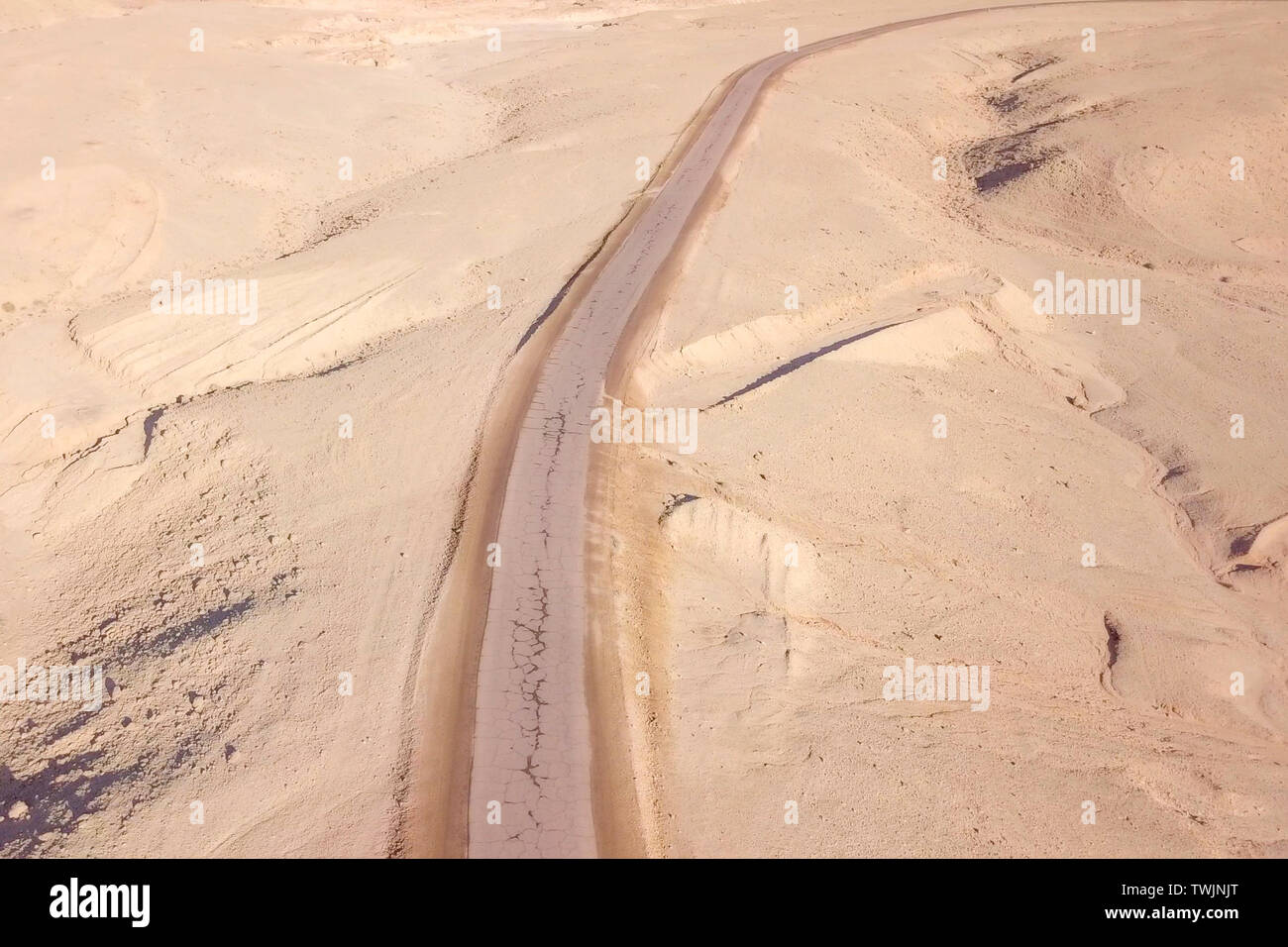 Old Desert road with cracked asphalt, Top down aerial image Stock Photo ...