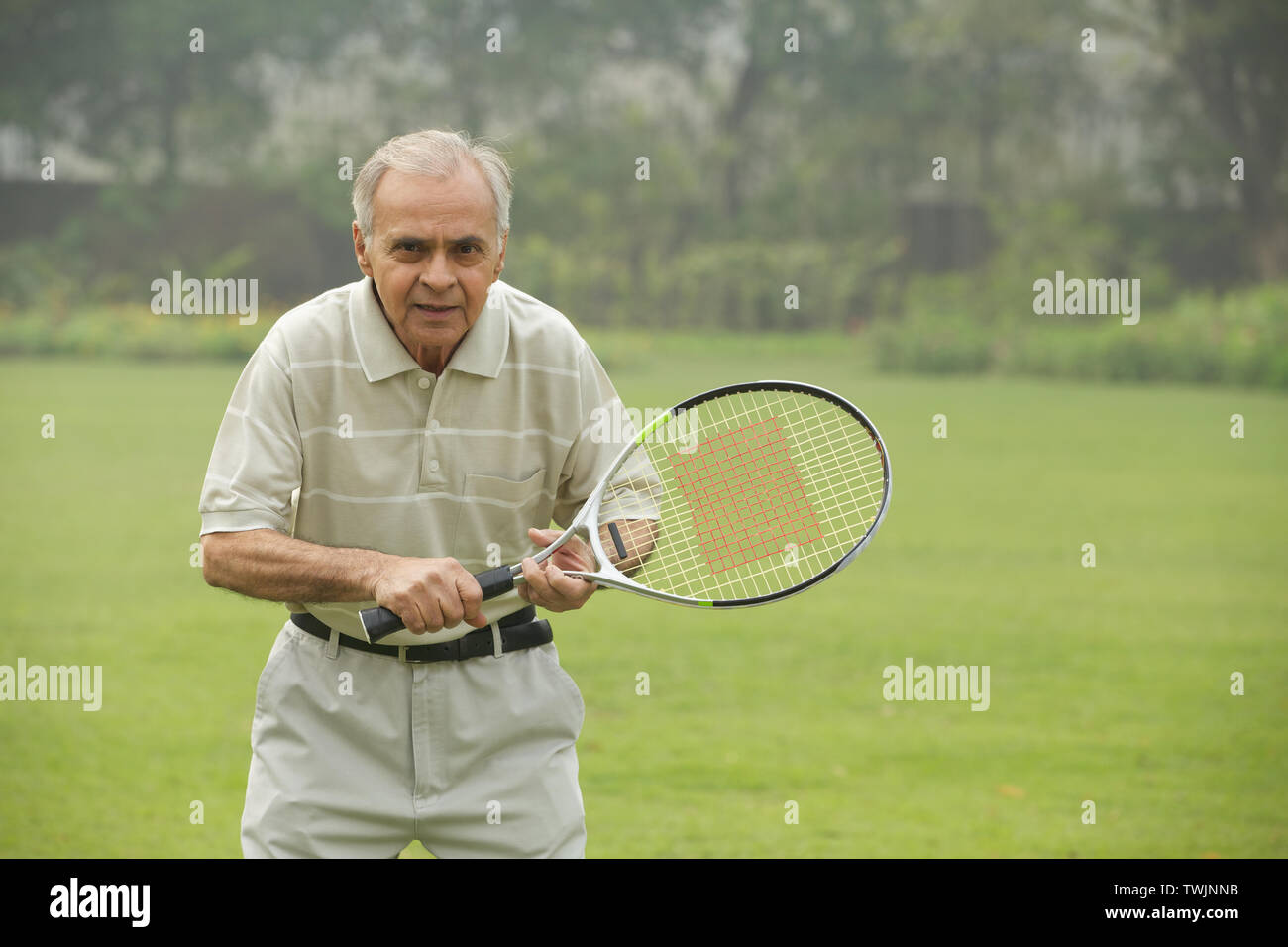 Old man playing badminton Stock Photo - Alamy