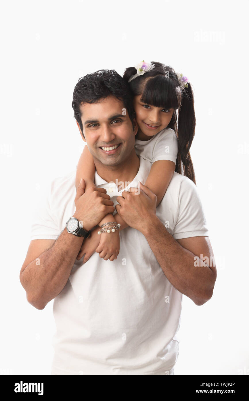 Girl riding on the back of her father Stock Photo - Alamy