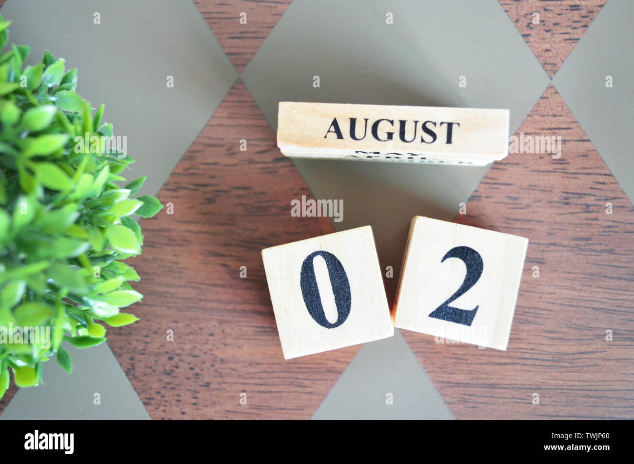 Date of August with leaf on diamond pattern table for background Stock ...