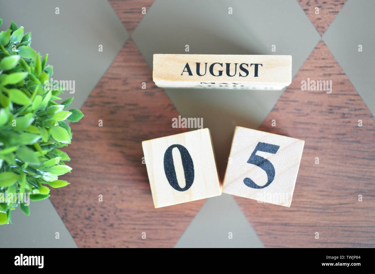 Date of August with leaf on diamond pattern table for background Stock ...