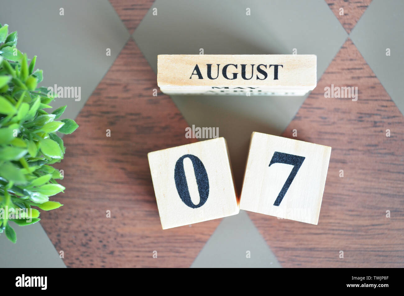 Date of August with leaf on diamond pattern table for background Stock ...