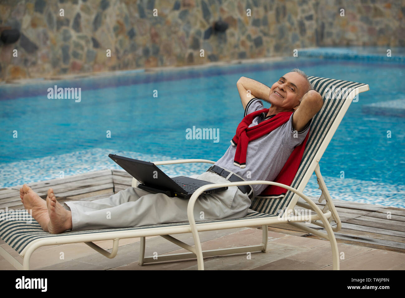 Man sitting poolside barefoot hi-res stock photography and images - Alamy