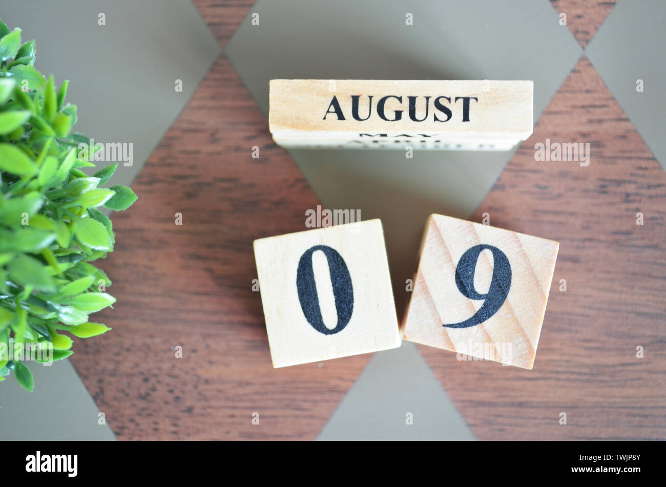 Date of August with leaf on diamond pattern table for background Stock ...