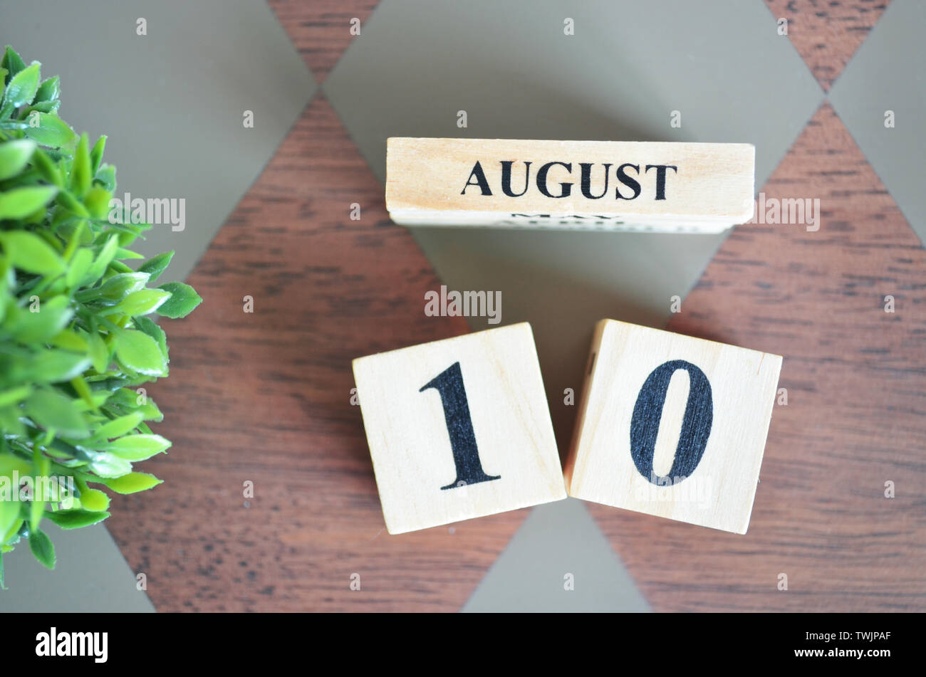 Date of August with leaf on diamond pattern table for background Stock ...