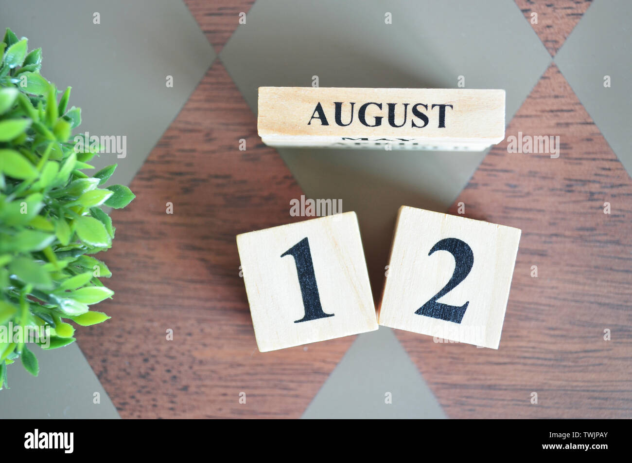 Date of August with leaf on diamond pattern table for background Stock ...