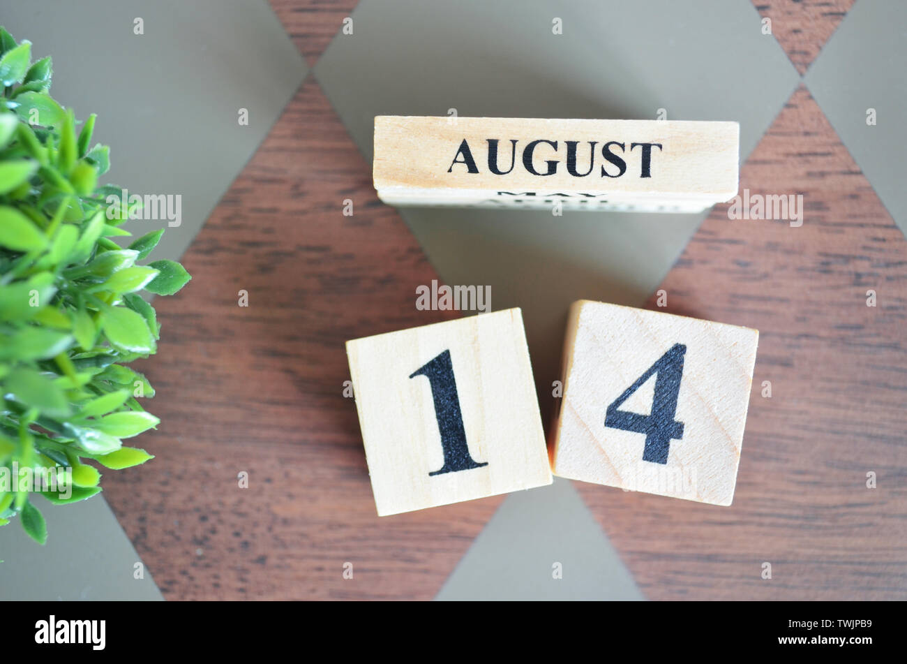 Date of August with leaf on diamond pattern table for background Stock ...