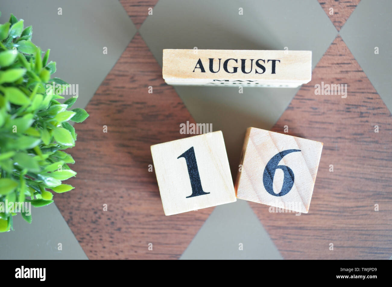 Date of August with leaf on diamond pattern table for background Stock ...