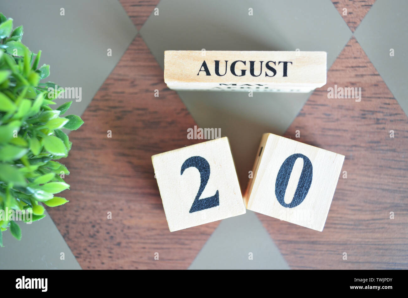 Date of August with leaf on diamond pattern table for background Stock ...