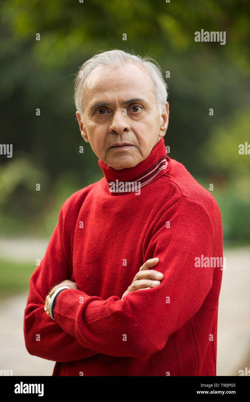 Portrait of an old man standing with his arms crossed Stock Photo - Alamy