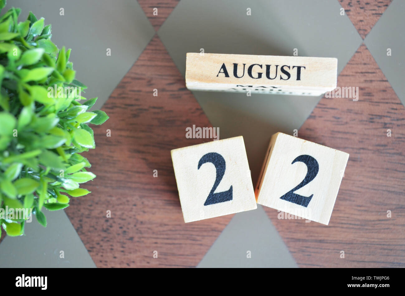 Date of August with leaf on diamond pattern table for background Stock ...