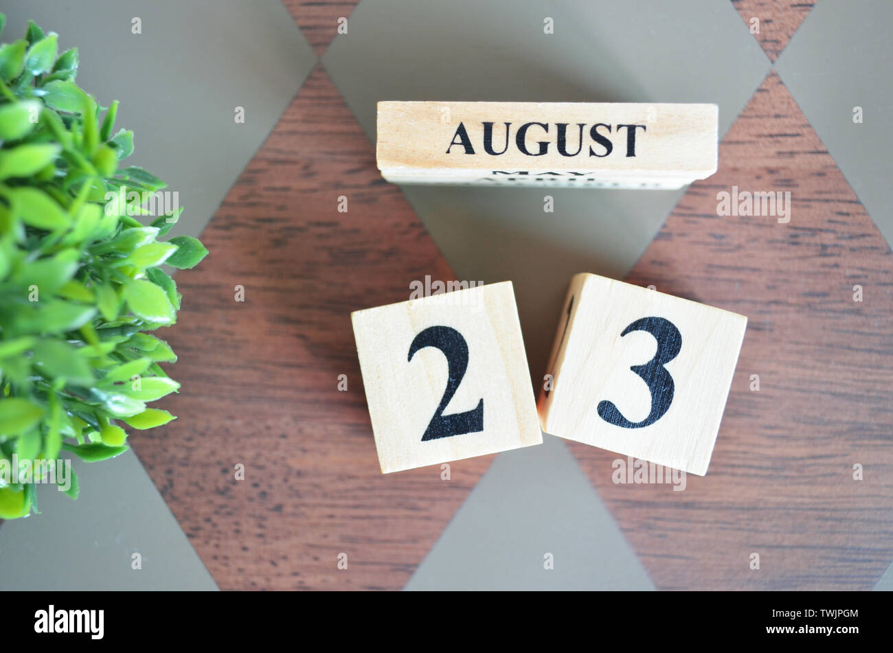 Date of August with leaf on diamond pattern table for background Stock ...