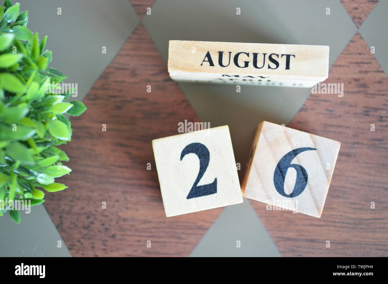 Date of August with leaf on diamond pattern table for background Stock ...