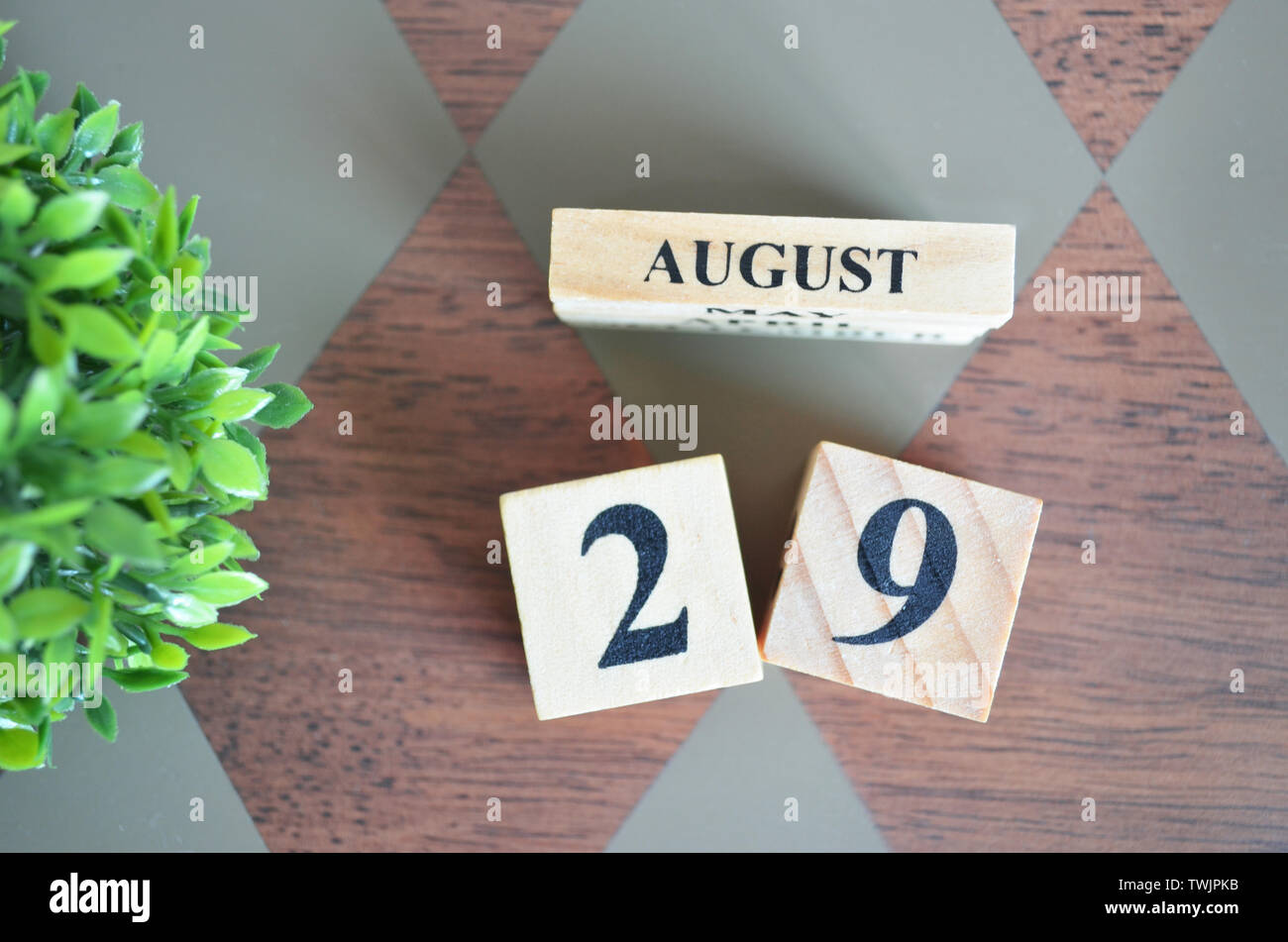 Date of August with leaf on diamond pattern table for background Stock ...