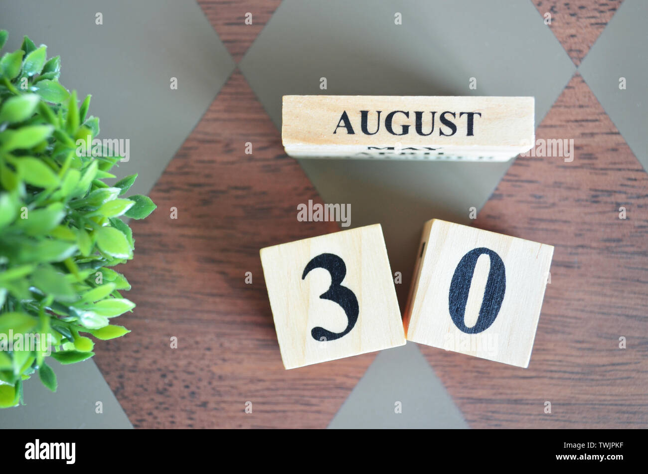Date of August with leaf on diamond pattern table for background Stock ...