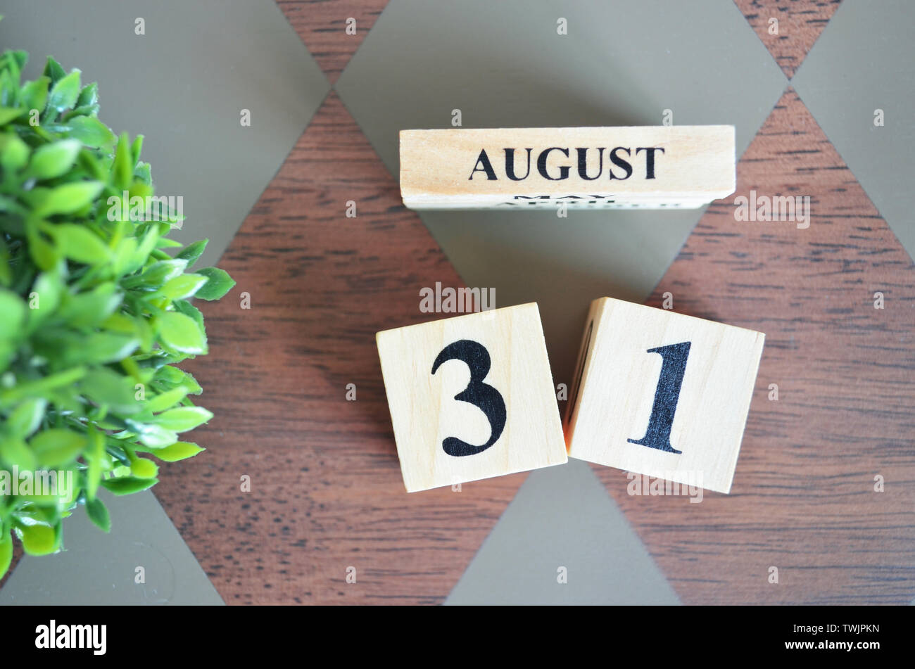 Date of August with leaf on diamond pattern table for background Stock ...