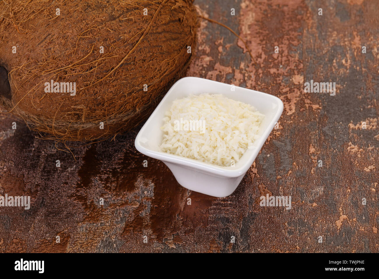 Coconut shredded chip with nut over wooden background Stock Photo - Alamy