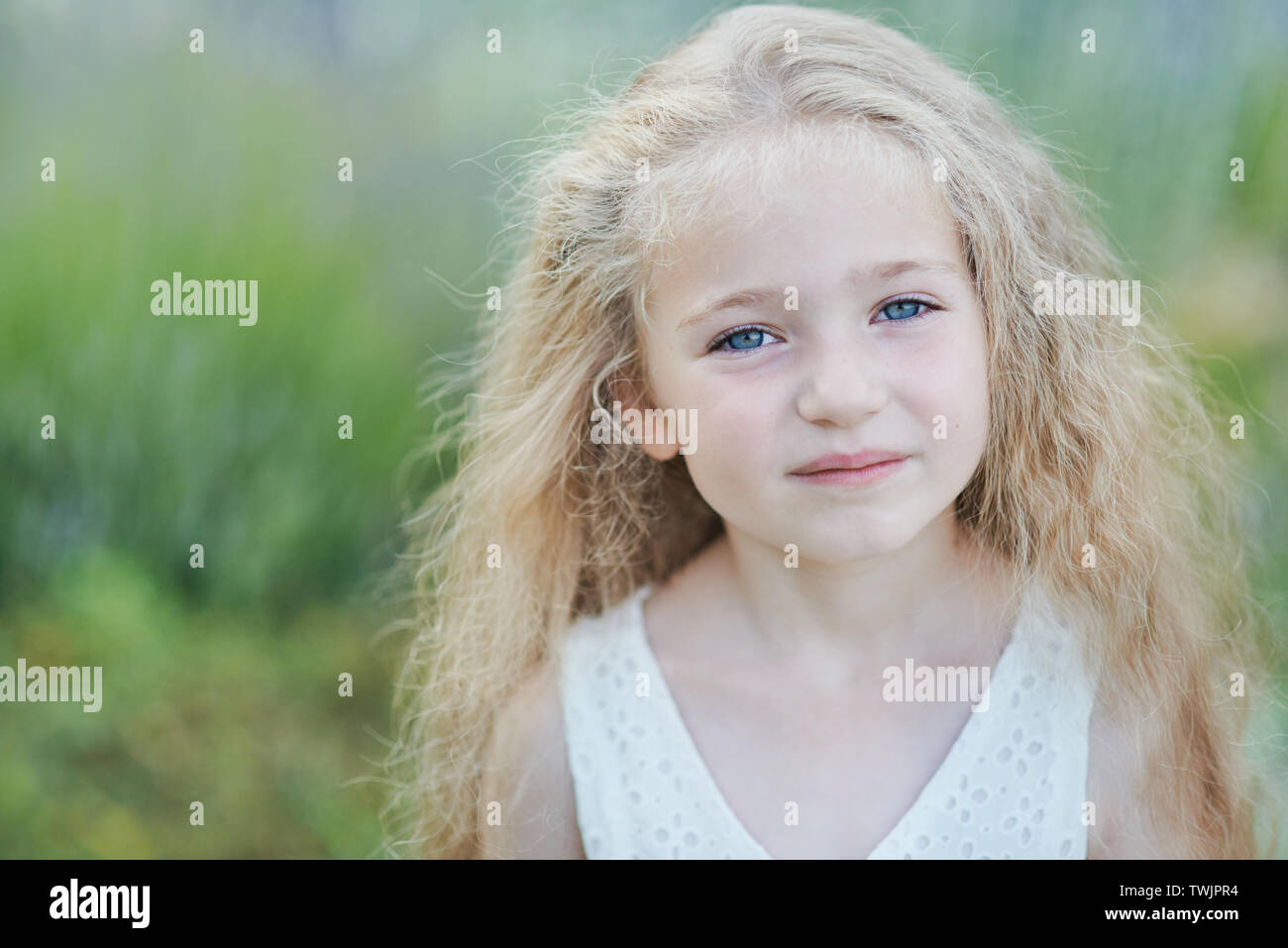 Close up portrait of pretty, blue eyed, fair skinned girl with happy ...